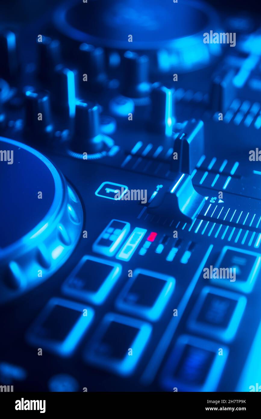 DJ mixing desk turntable in colored wedding disco party lights Stock ...
