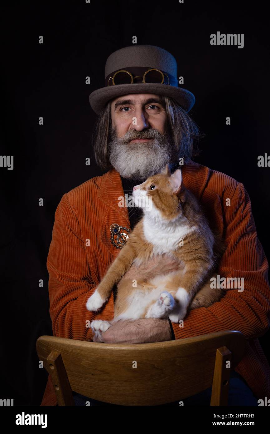 A gray-haired bearded intellectual of mature age in a steampunk hat ...