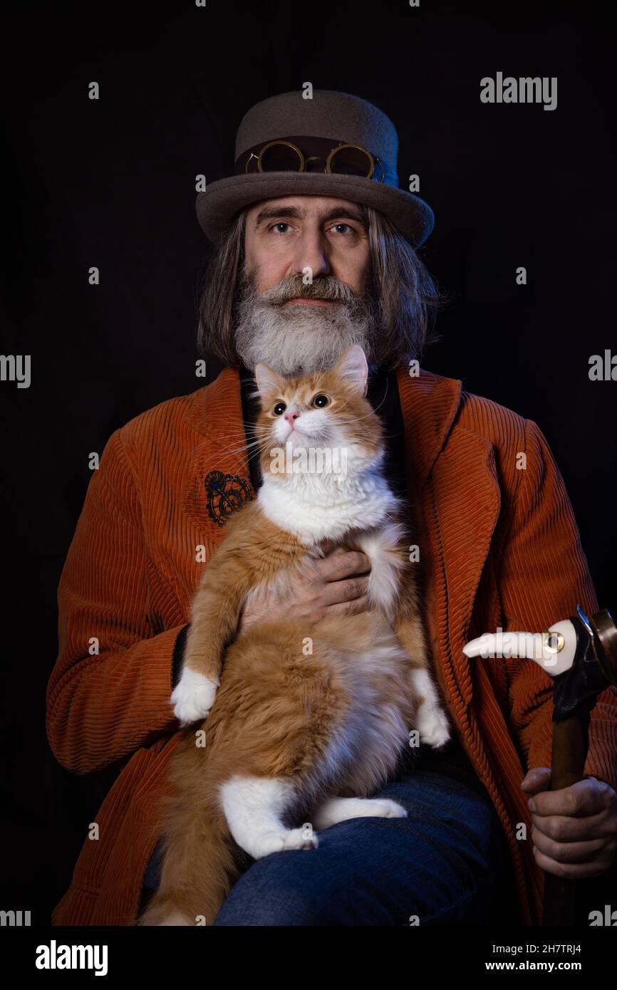 A gray-haired bearded intellectual of mature age in a steampunk hat ...