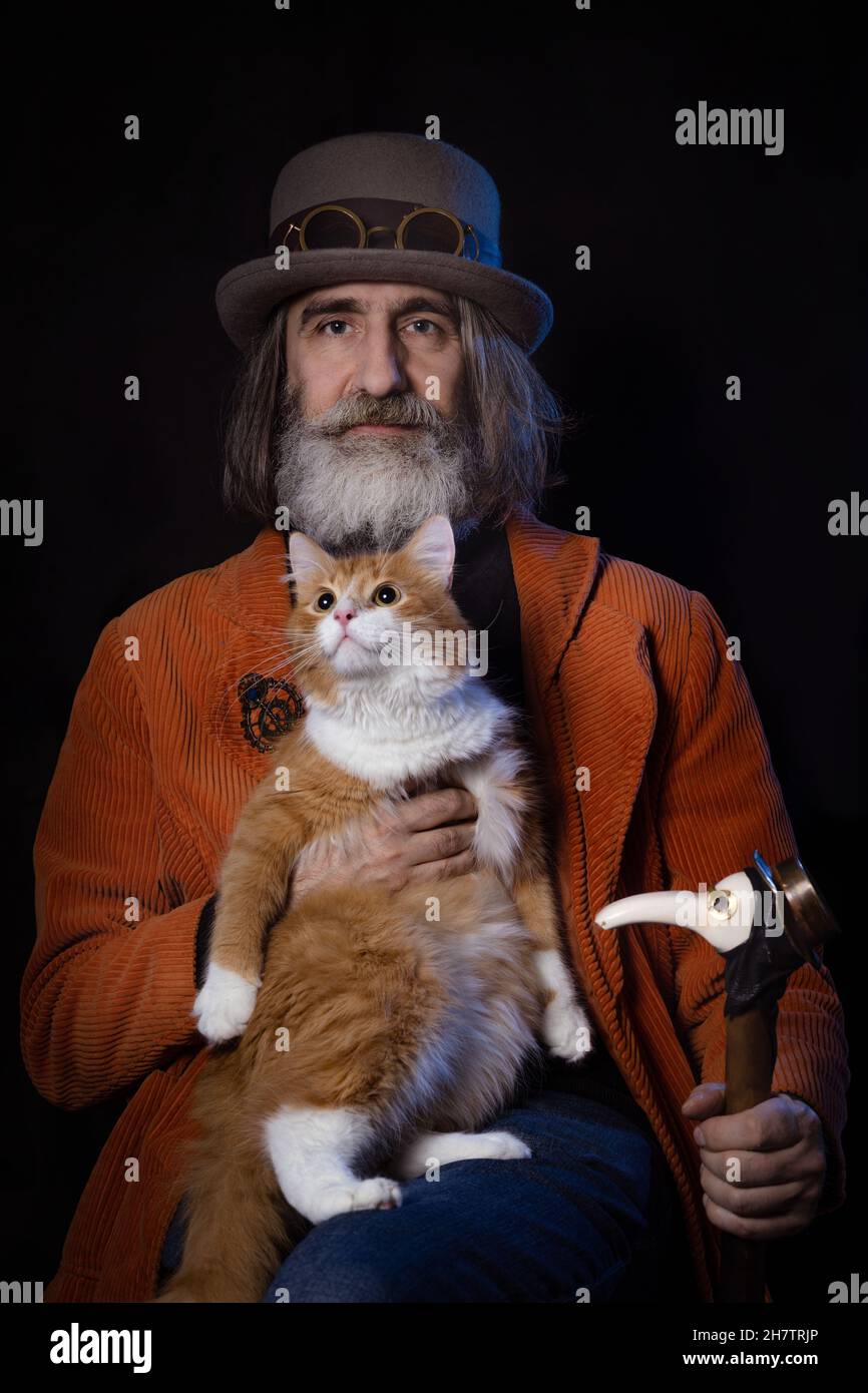A gray-haired bearded intellectual of mature age in a steampunk hat ...