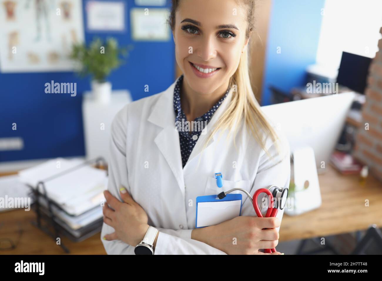 Cute medical worker or head doctor in uniform posing in clinic office ...