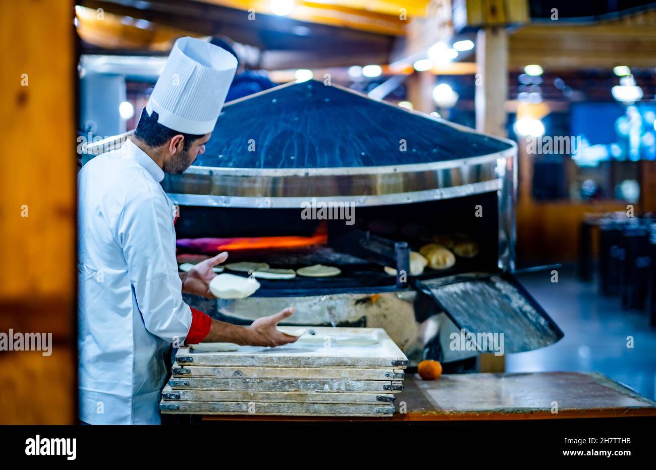 Arab chef preparing dinner in restaurant kitchen Stock Photo - Alamy