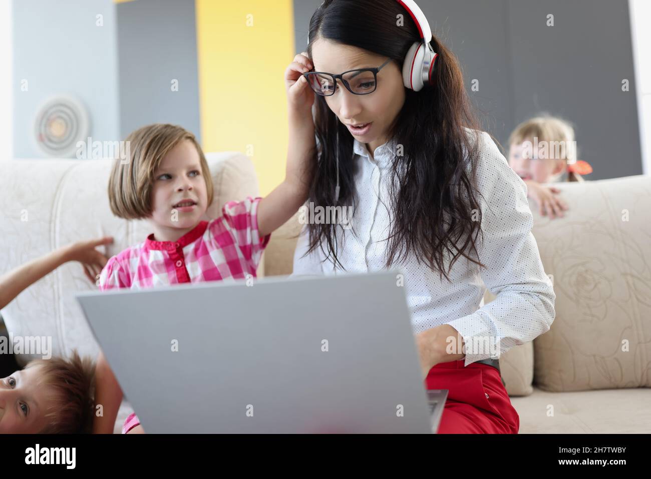 Mother busy with work on laptop from home deadline to do Stock Photo ...