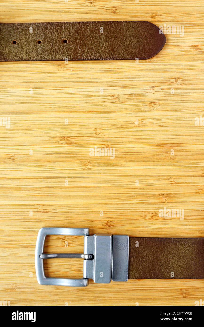 Leather belt hinges on wooden background with copy space Stock Photo ...