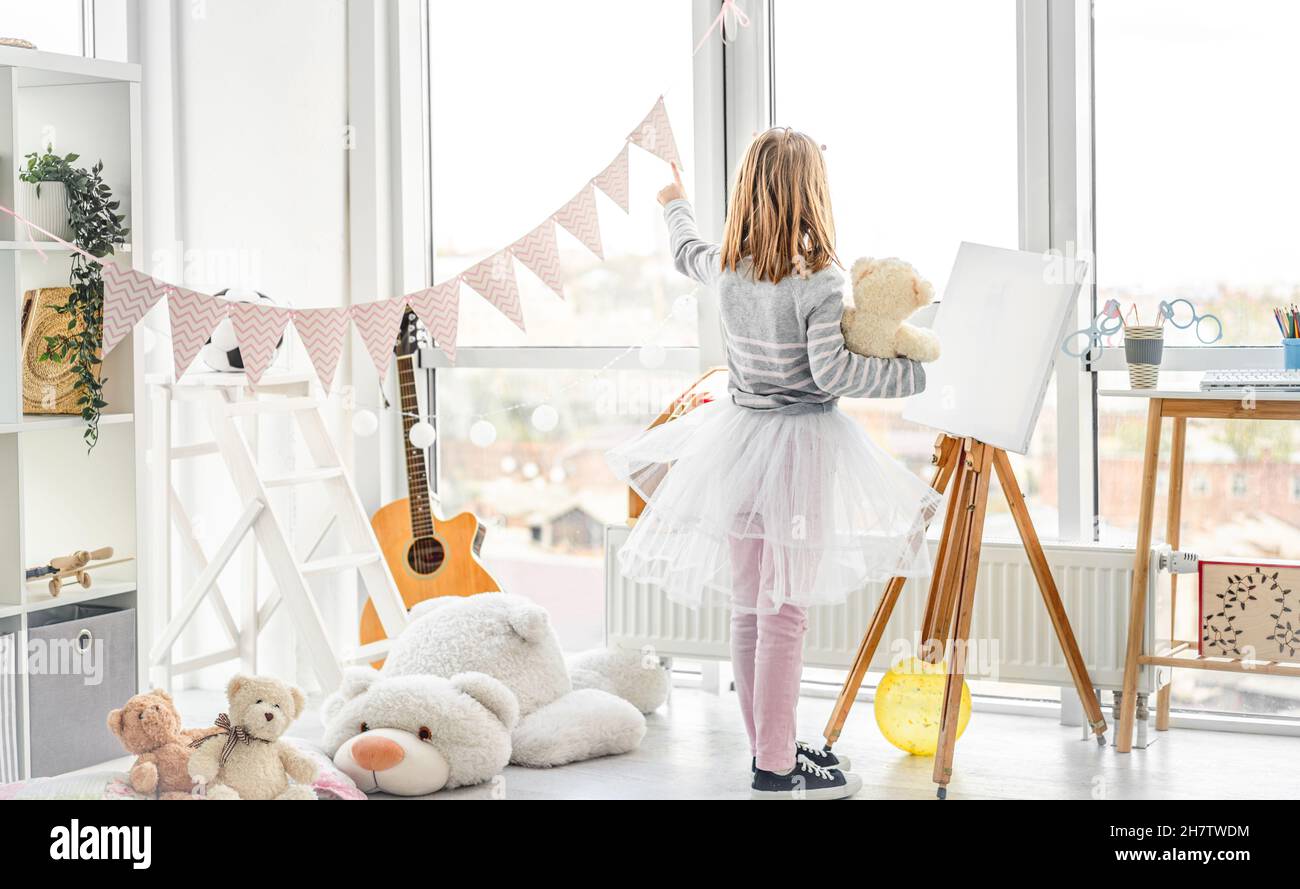 Cute little girl pointing at window Stock Photo - Alamy