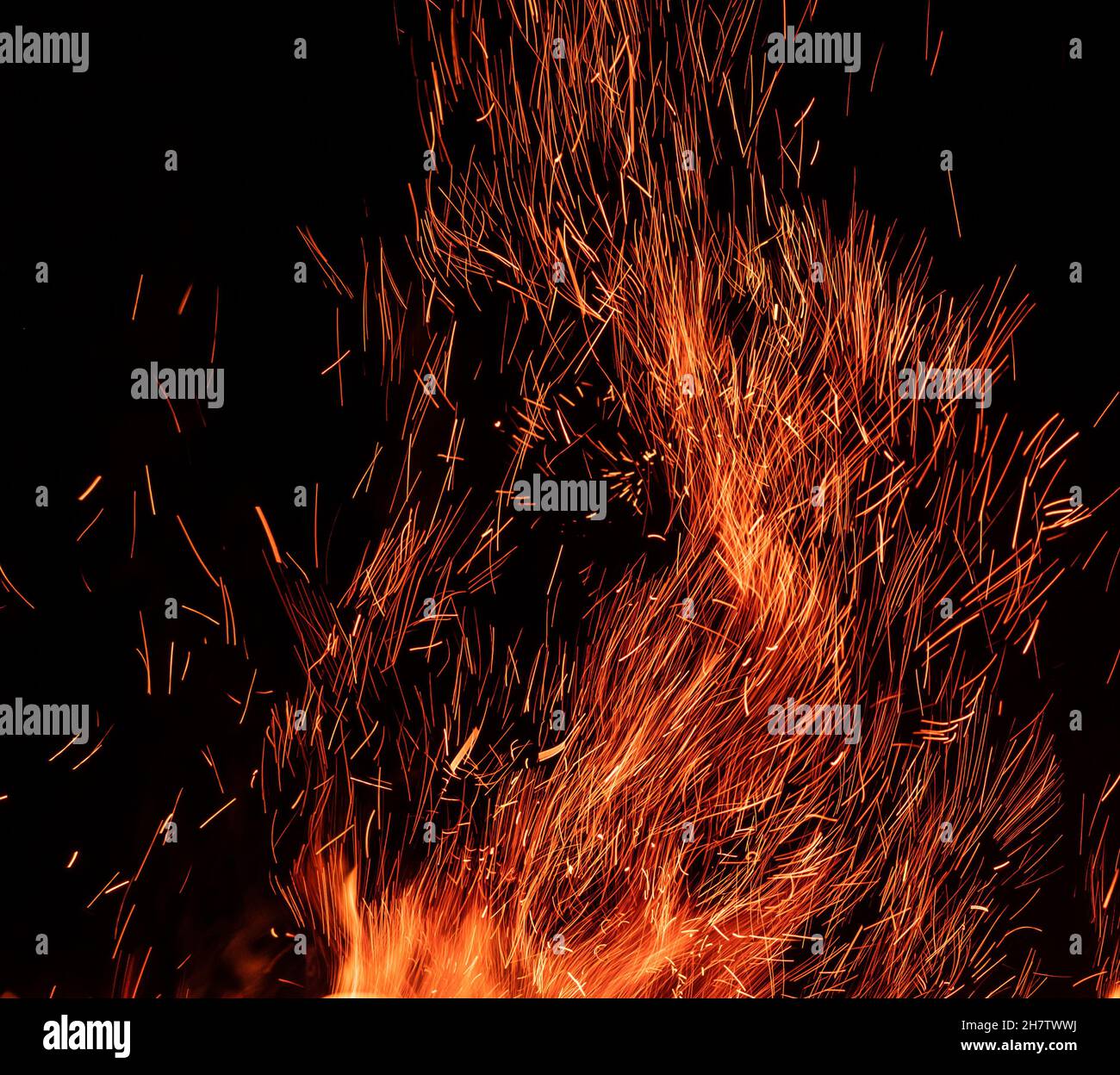Scattering of sparks from fire Stock Photo - Alamy
