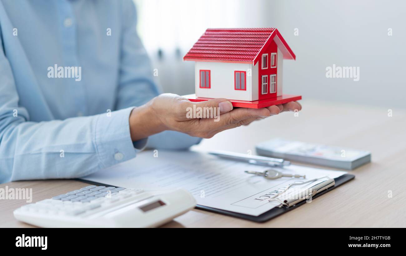 The real estate concept the realtor presenting his work towards his ...