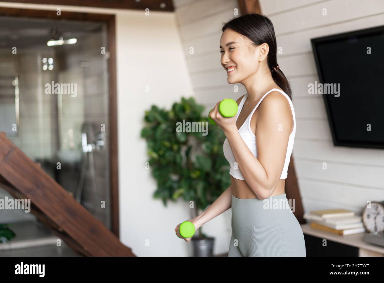 Active and healthy asian girl with fit body doing fitness exercises at ...