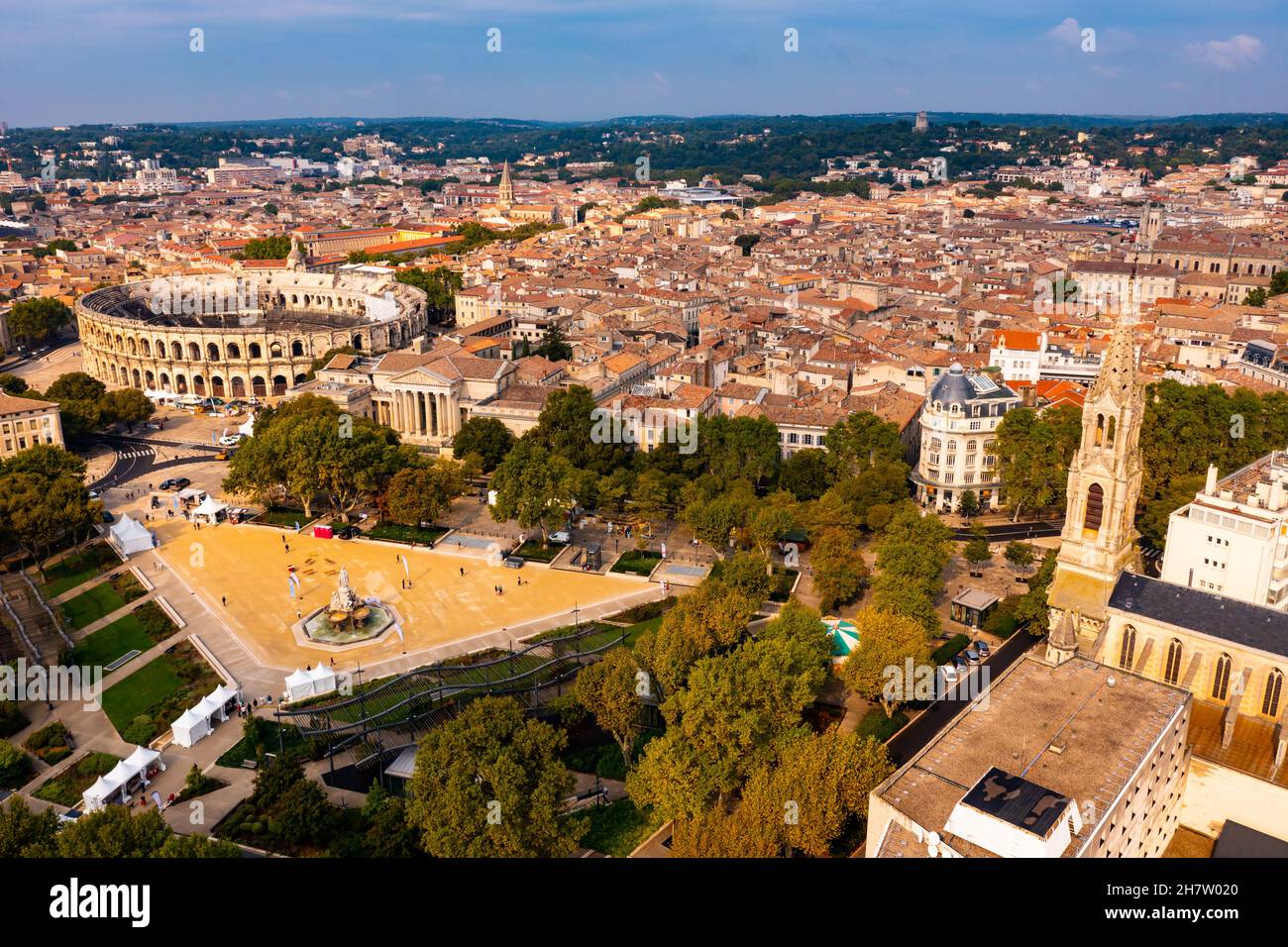 Aerial view of Roman amphitheatre on background with cityscape of Nimes ...