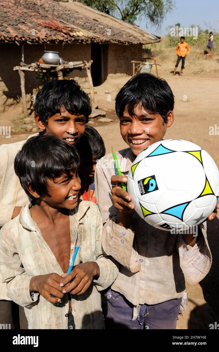 INDIA, Madhya Pradesh, laughing smiling children hold a fairtrade ...