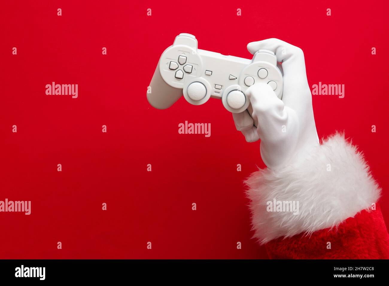 Father Christmas holding a video game controller against a red ...