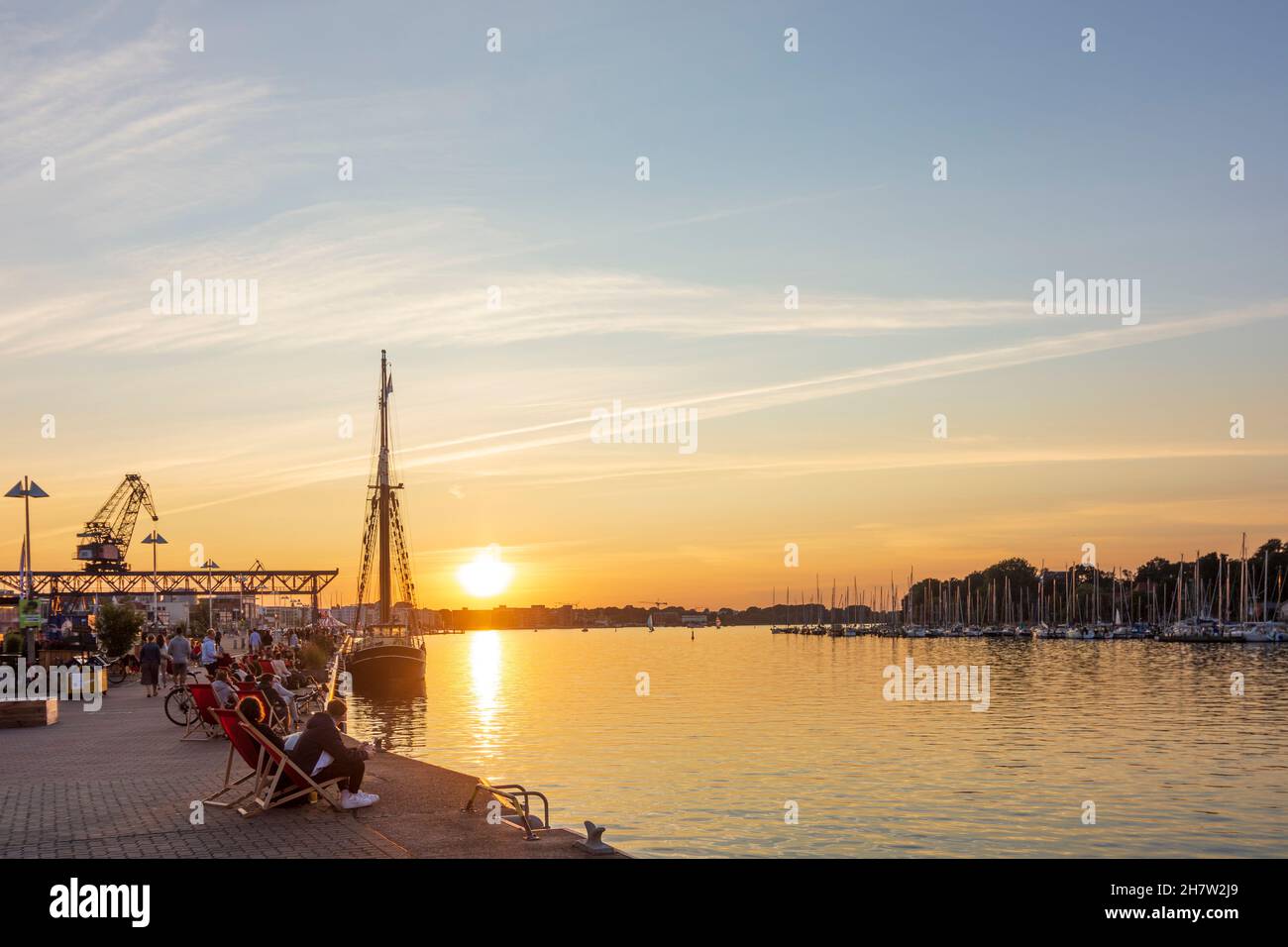 People sitting on quay in ostsee baltic sea hi-res stock photography ...
