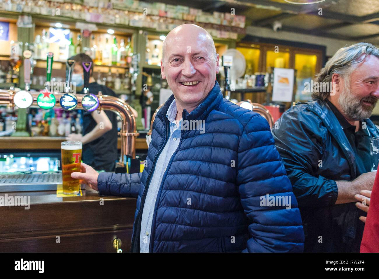 Social drinkers stand at the bar in the Scotsman's Lounge for the first ...