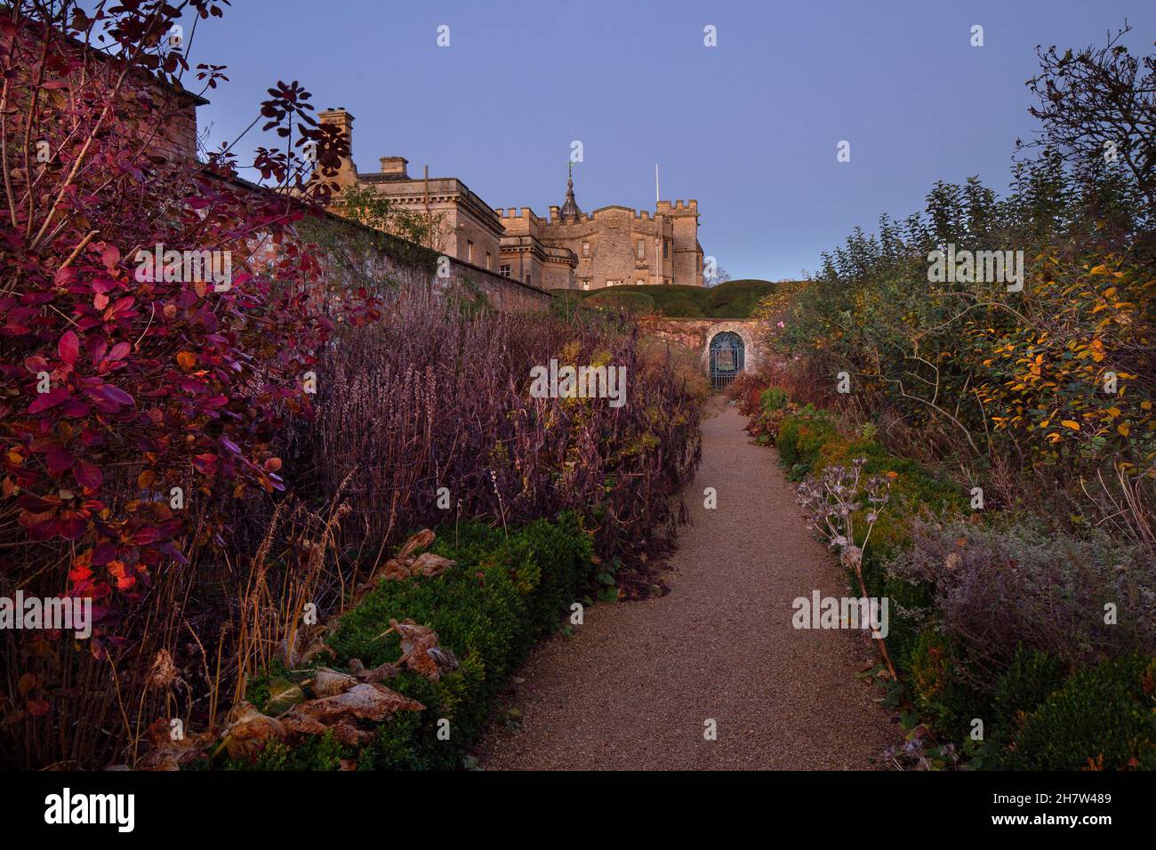 Gate entrance and formal gardens in early autumn light at Rousham House ...