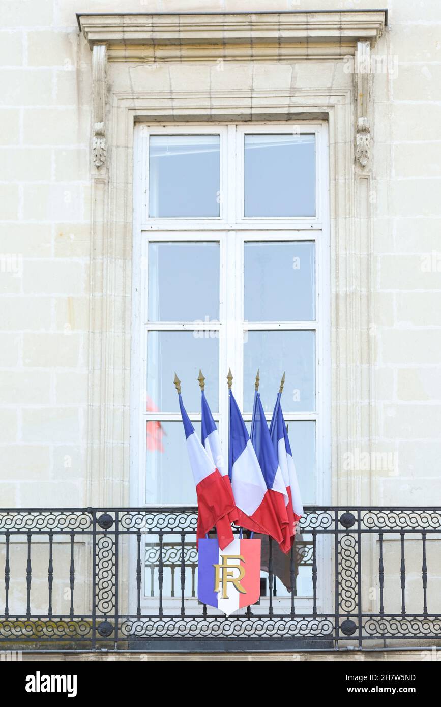The French flag hung on the tenement house, waving in the wind Stock ...