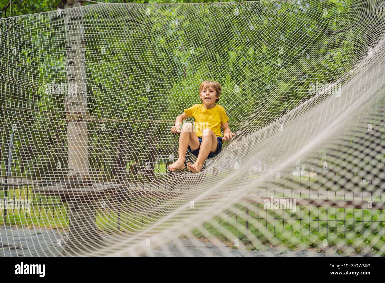 practice nets playground. boy plays in the playground shielded with a ...