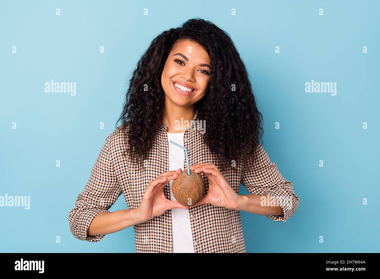Photo of excited adorable dark skin lady wear plaid shirt drinking coco ...