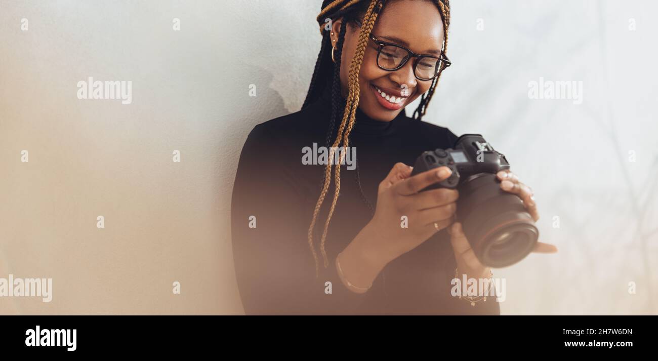 Getting ready to capture some pictures. Happy female photographer ...