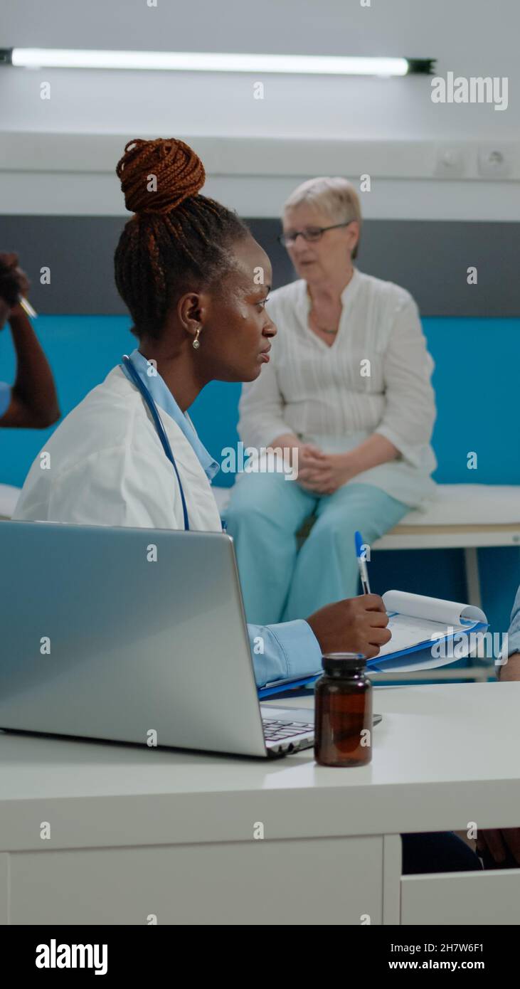 Doctor checking on elder patient healthcare in medical cabinet at ...