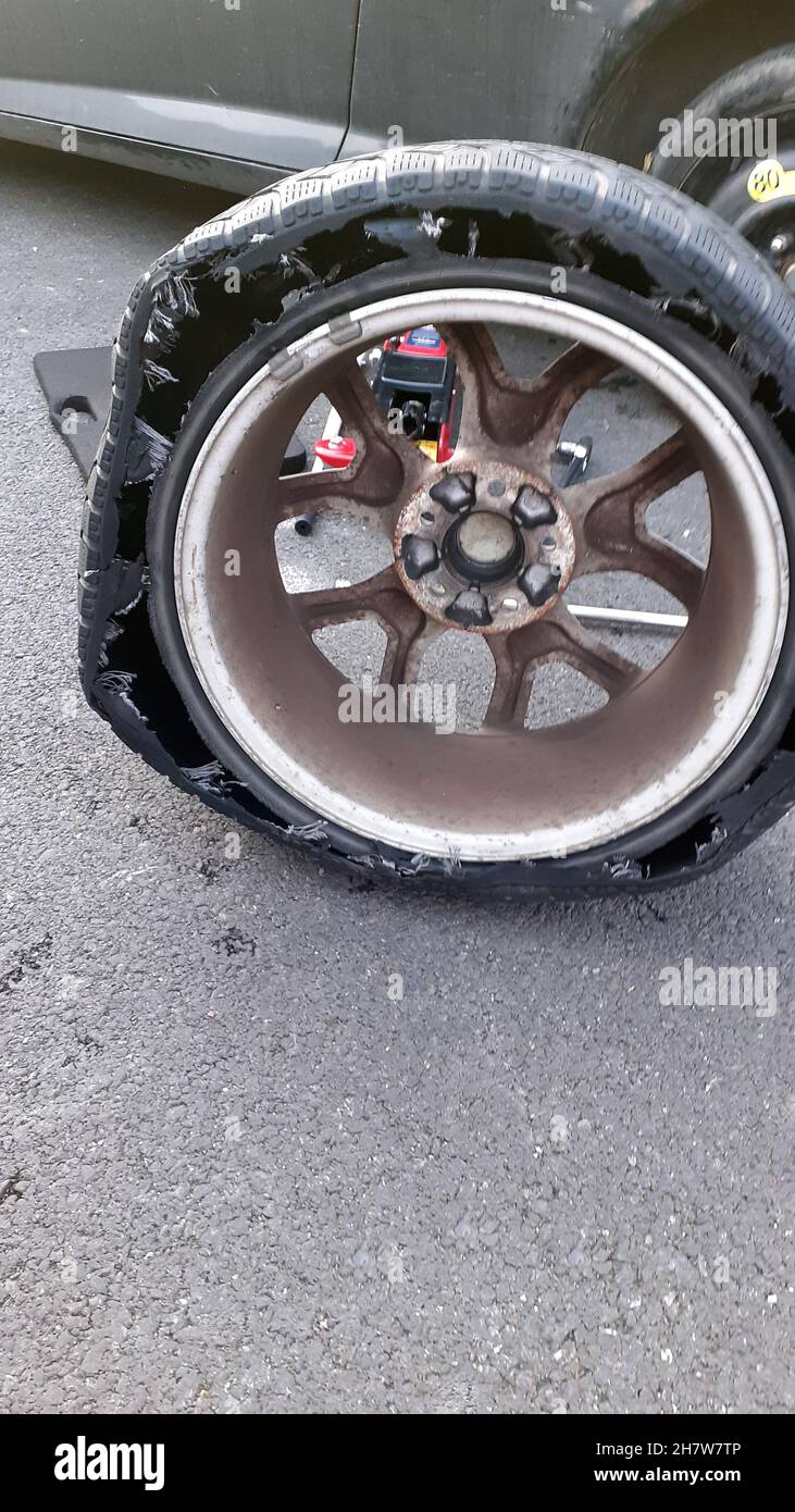 Destroyed tyre on alloy wheel, walls have disintegrated due to running ...