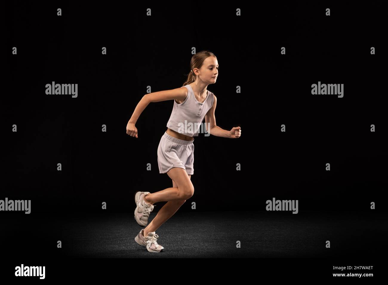 Portrait of girl, teenager, professional runner training isolated over ...