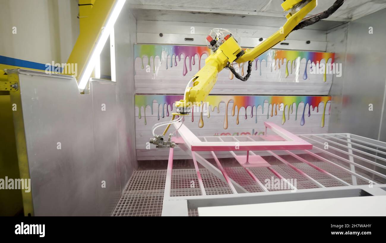 Industrial robotic arm paints frame. Action. Modern equipment for ...