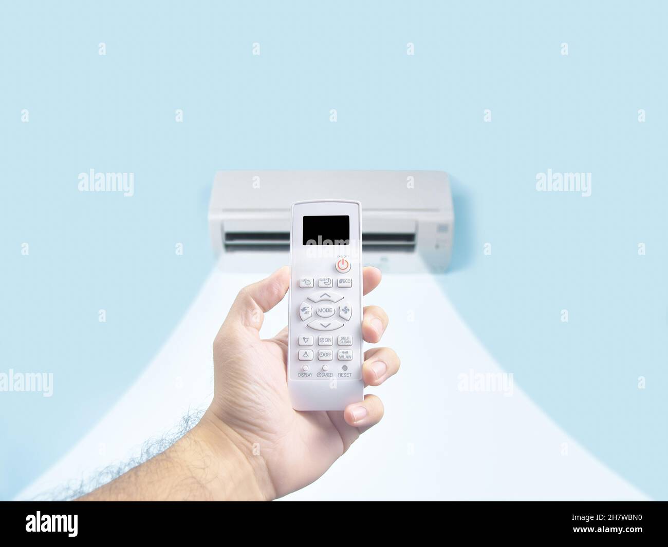 Human hand holding air conditioner remote control for regulate ...
