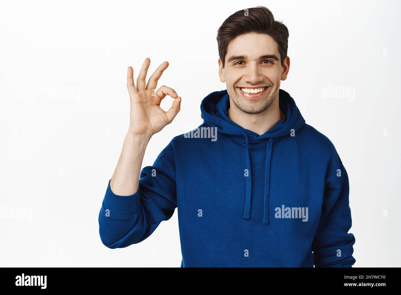 Okay. Smiling brunette guy confirms smth, say yes, showing ok sign in ...