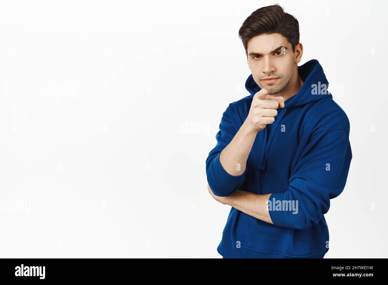 Suspicious man with frowned face, pointing finger at camera and looks ...