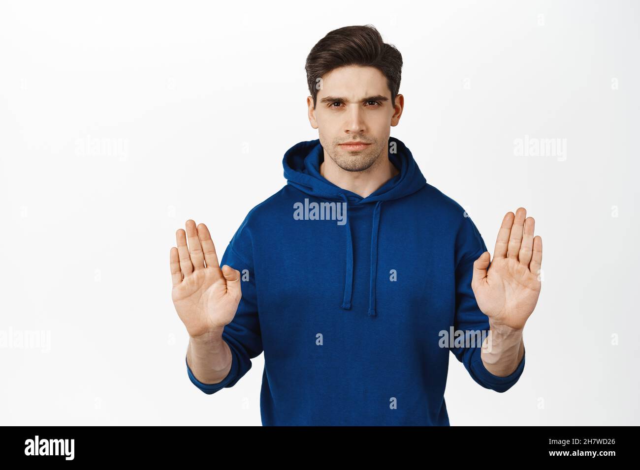 Stop this. Serious concerned man showing block, taboo gesture, say no ...
