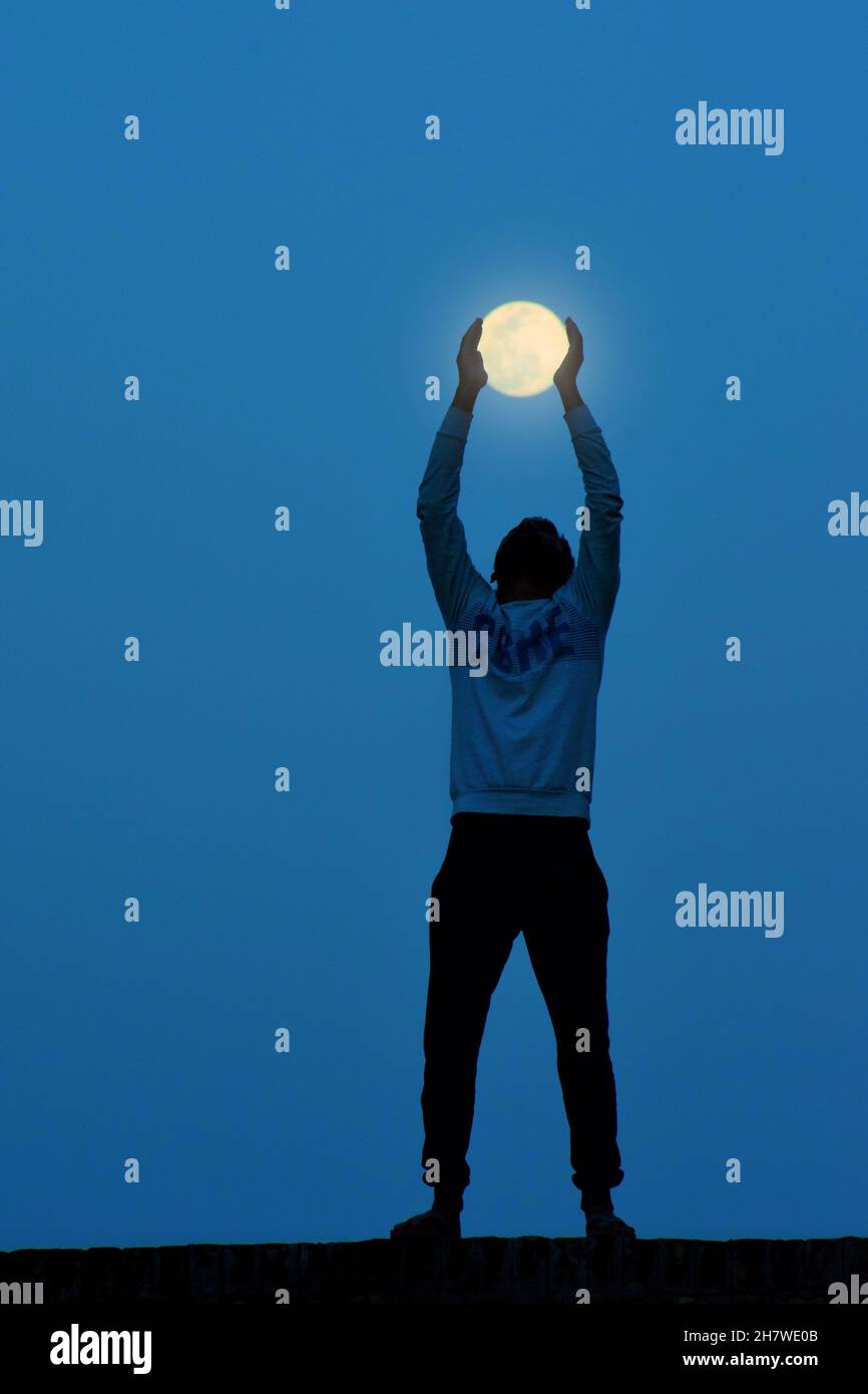 A man holding the moon like a beacon. HARYANA, INDIA: TRICK-of-the-eye ...