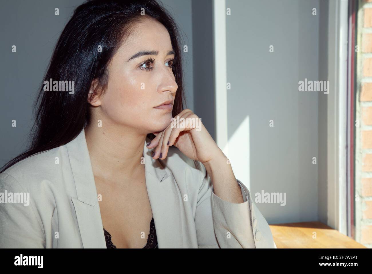 girl in cafe. woman looking out the window. young girl pondering ...