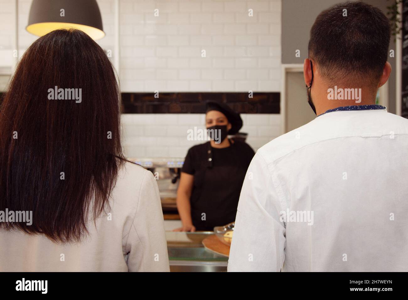 Couple ordering in coffee shop. Coffee shop employee serving the public ... Couple ordering in coffee shop. Coffee shop employee serving the public ...