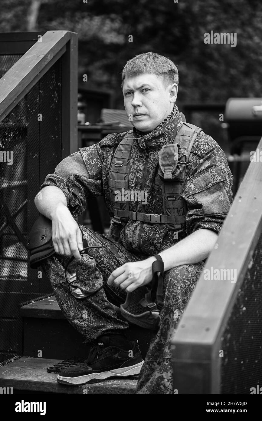 Fully equipped military men with automatic weapons getting ready to ...