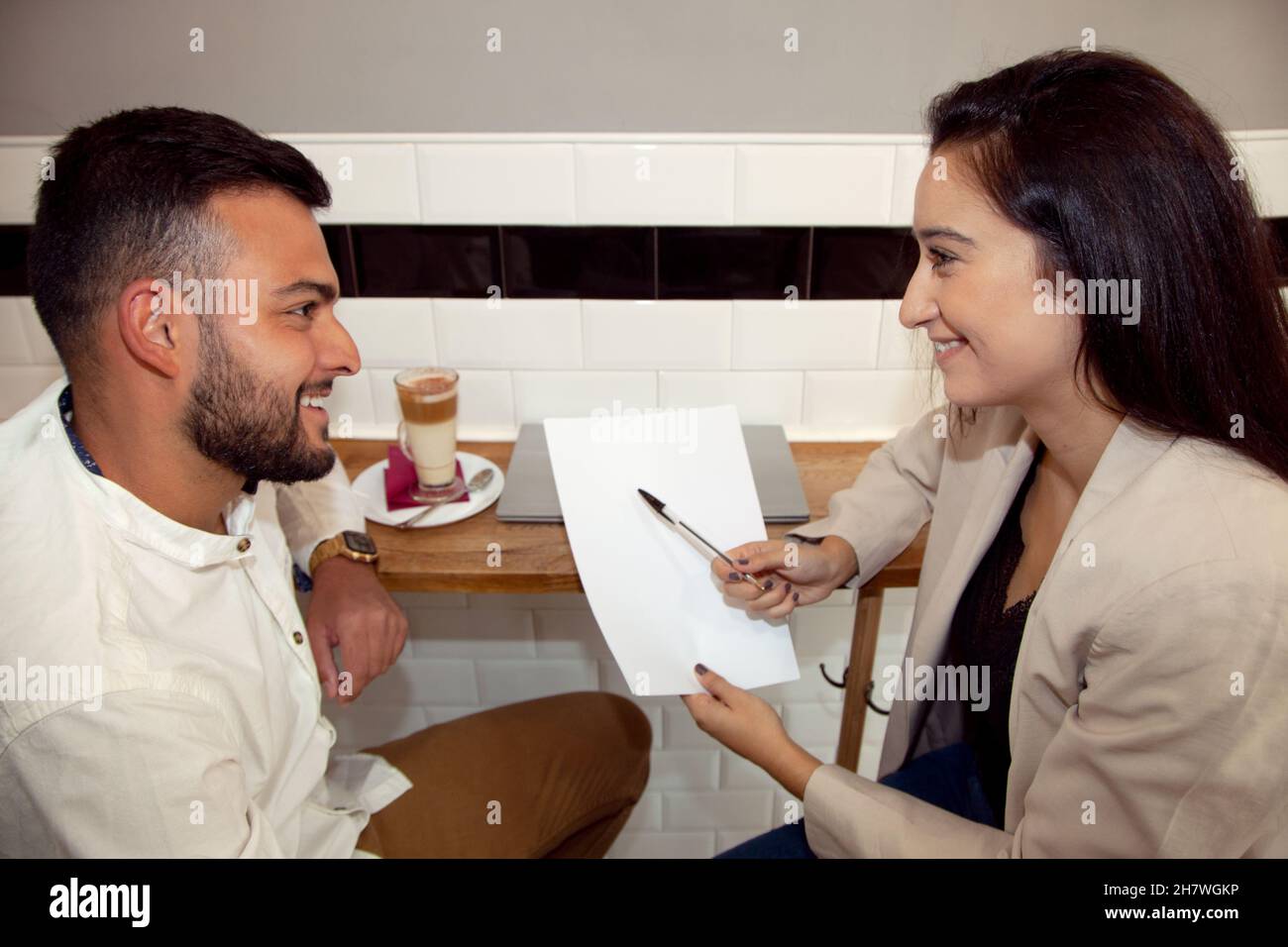 Couple checking their work. Couple looking at each other. man and woman ...