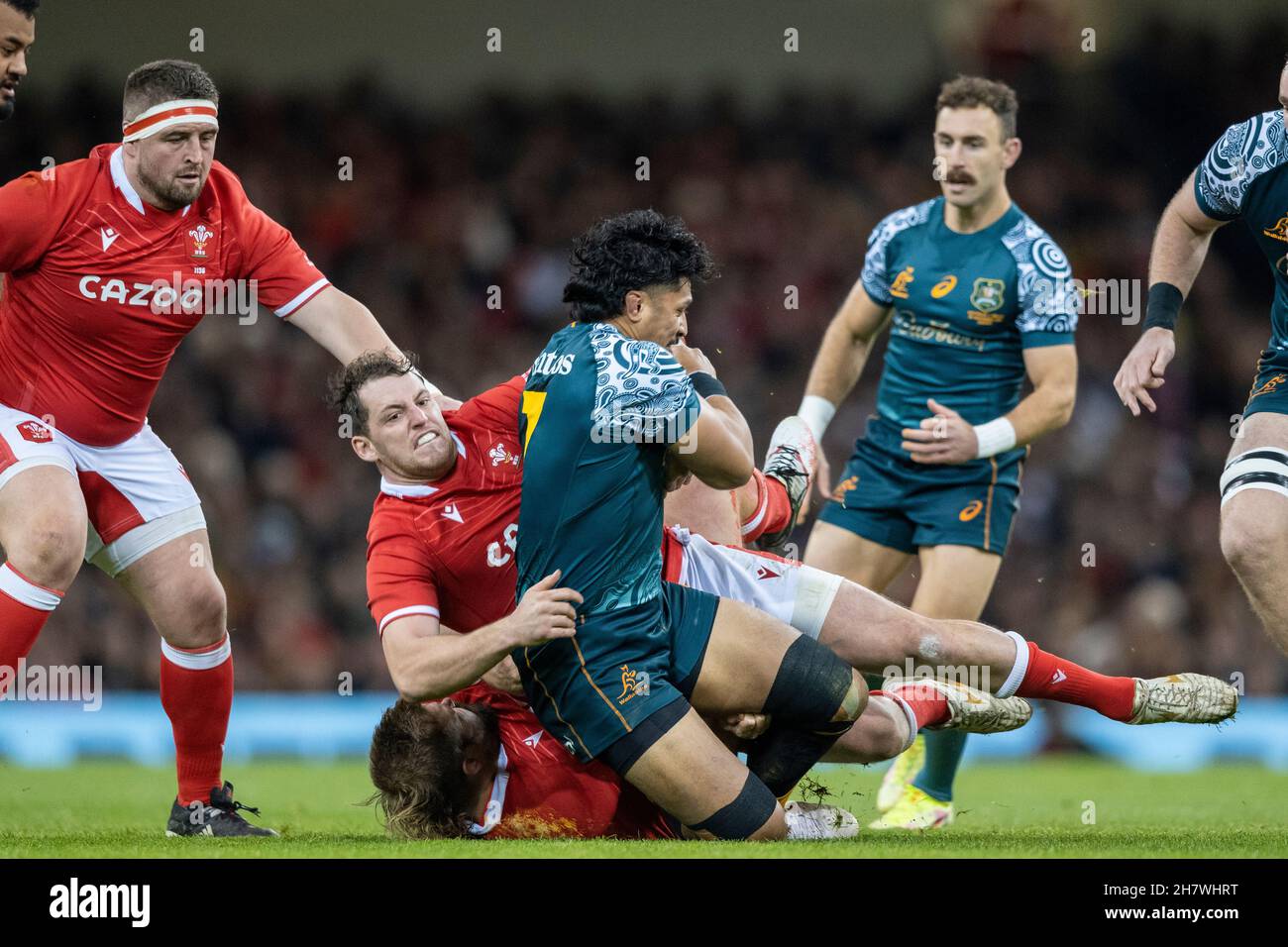 Wallabies' flanker, Pete Samu is tackled by Welsh front row partners ...
