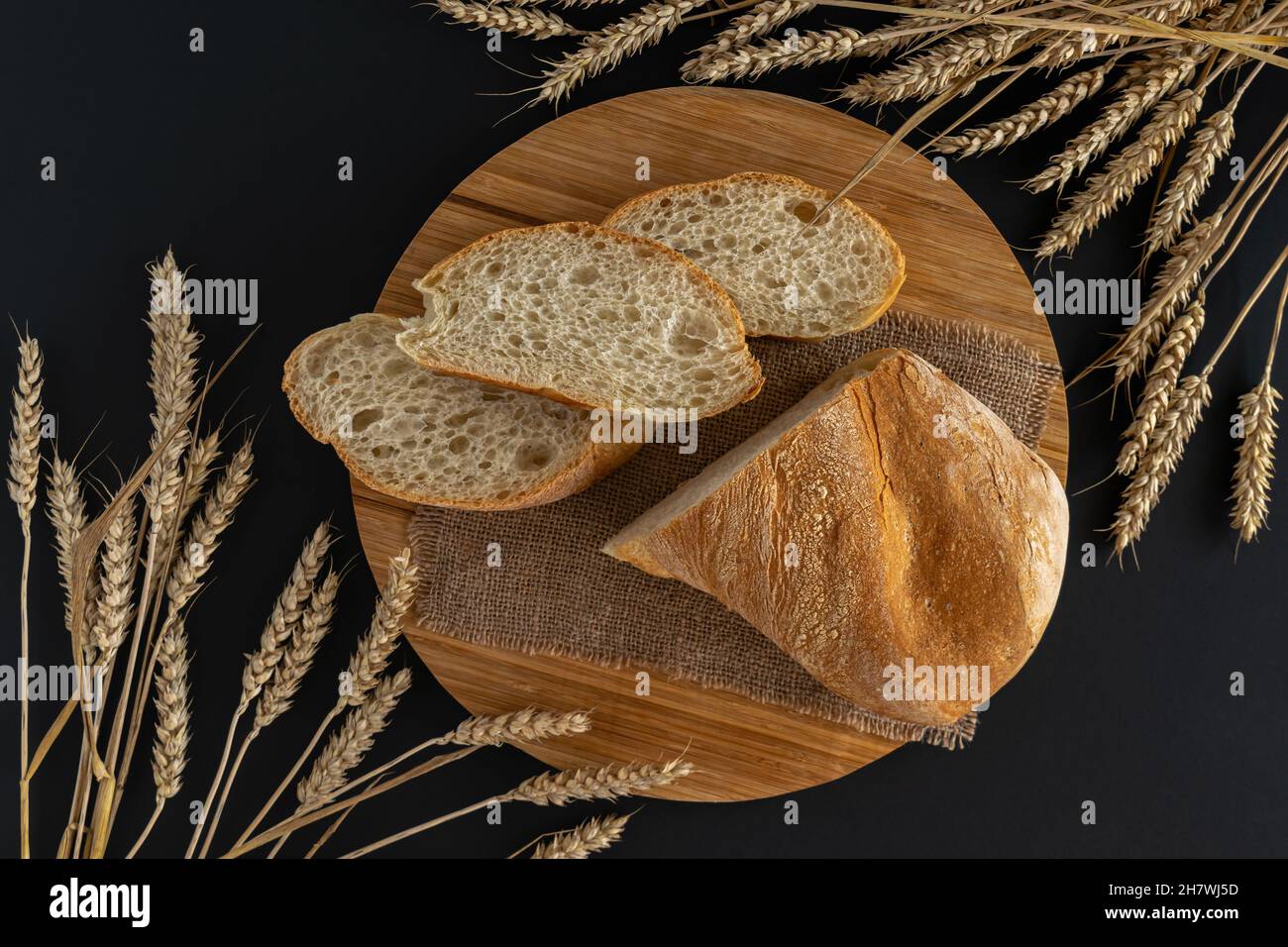 Advertising flyer. Food concept. Sliced bread on a wooden round board ...