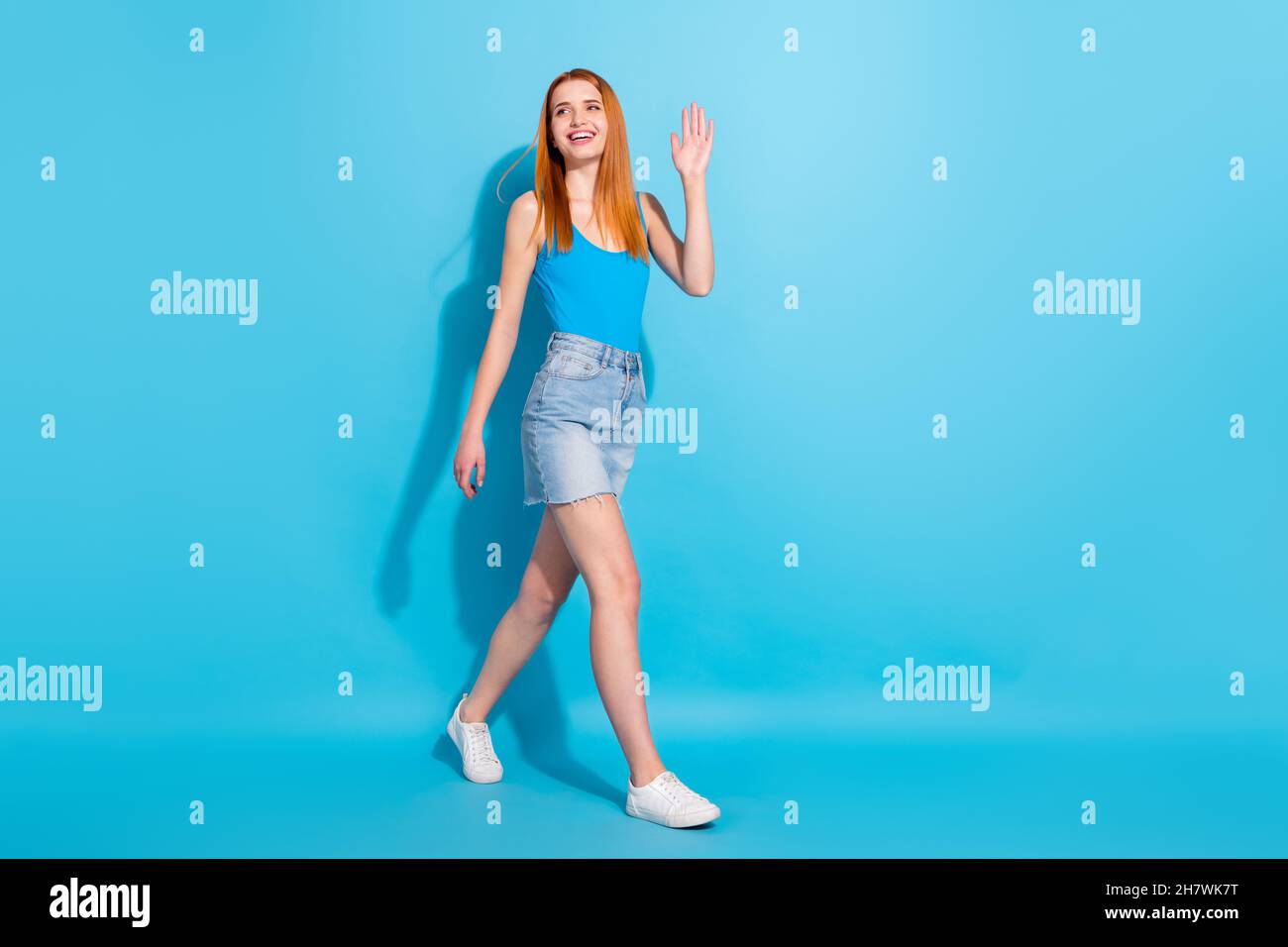 Full length body size view of attractive cheerful girl going waving ...