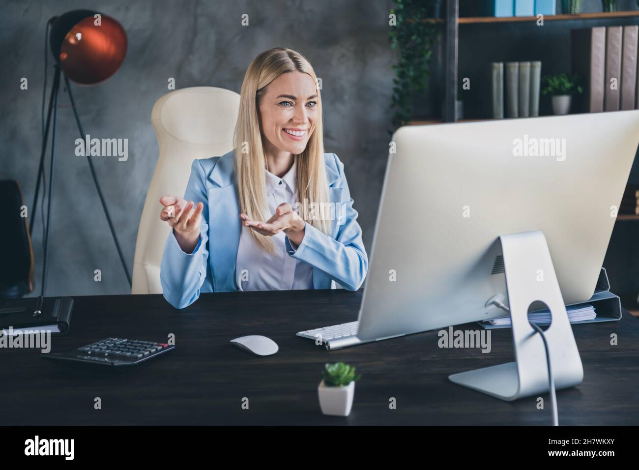 Photo of banker investor hr lady sit desk video call applicant tell job ...