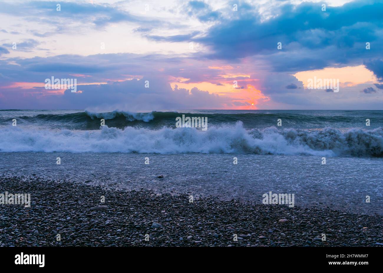 Fading waves and clearing skies after a storm Stock Photo - Alamy