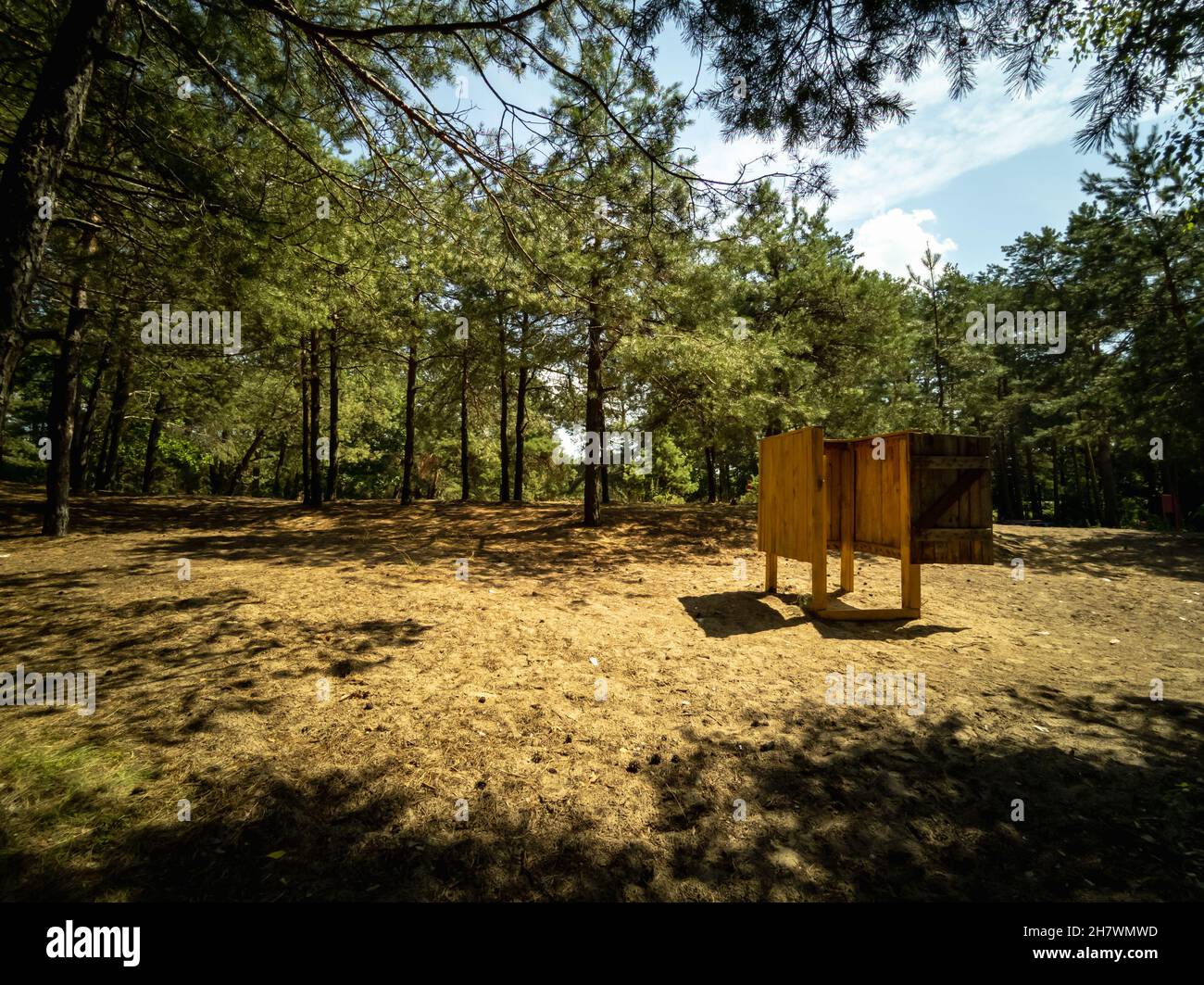 Changing booth on the beach by a forest lake in a pine forest. Camping ...