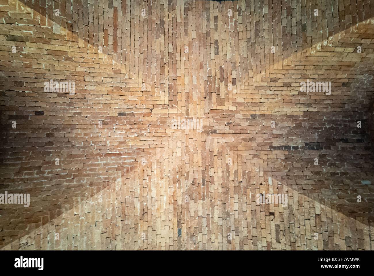 Arched vaulted ceiling in old structural red brick. Textured background ...