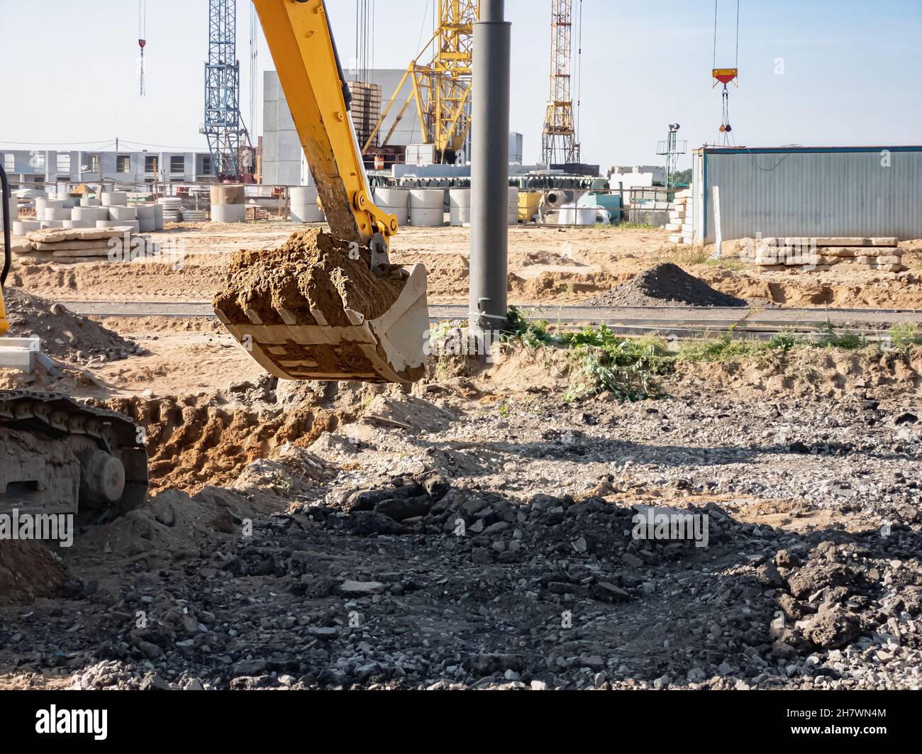 Construction site. Excavator bucket with earth. Construction of a road ...