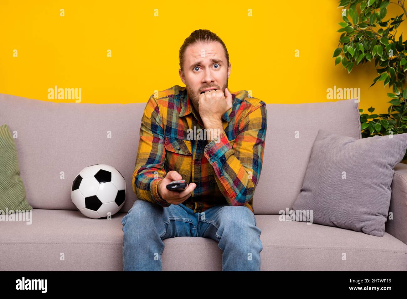Photo of nervous football fan guy sit sofa watch intense match ...