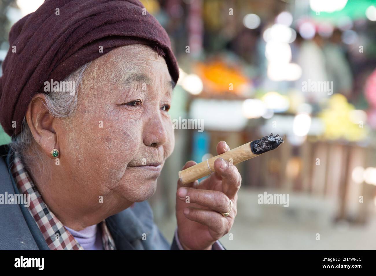 Portrait of old woman smoking cigar in the Nyaung U market Stock Photo ...
