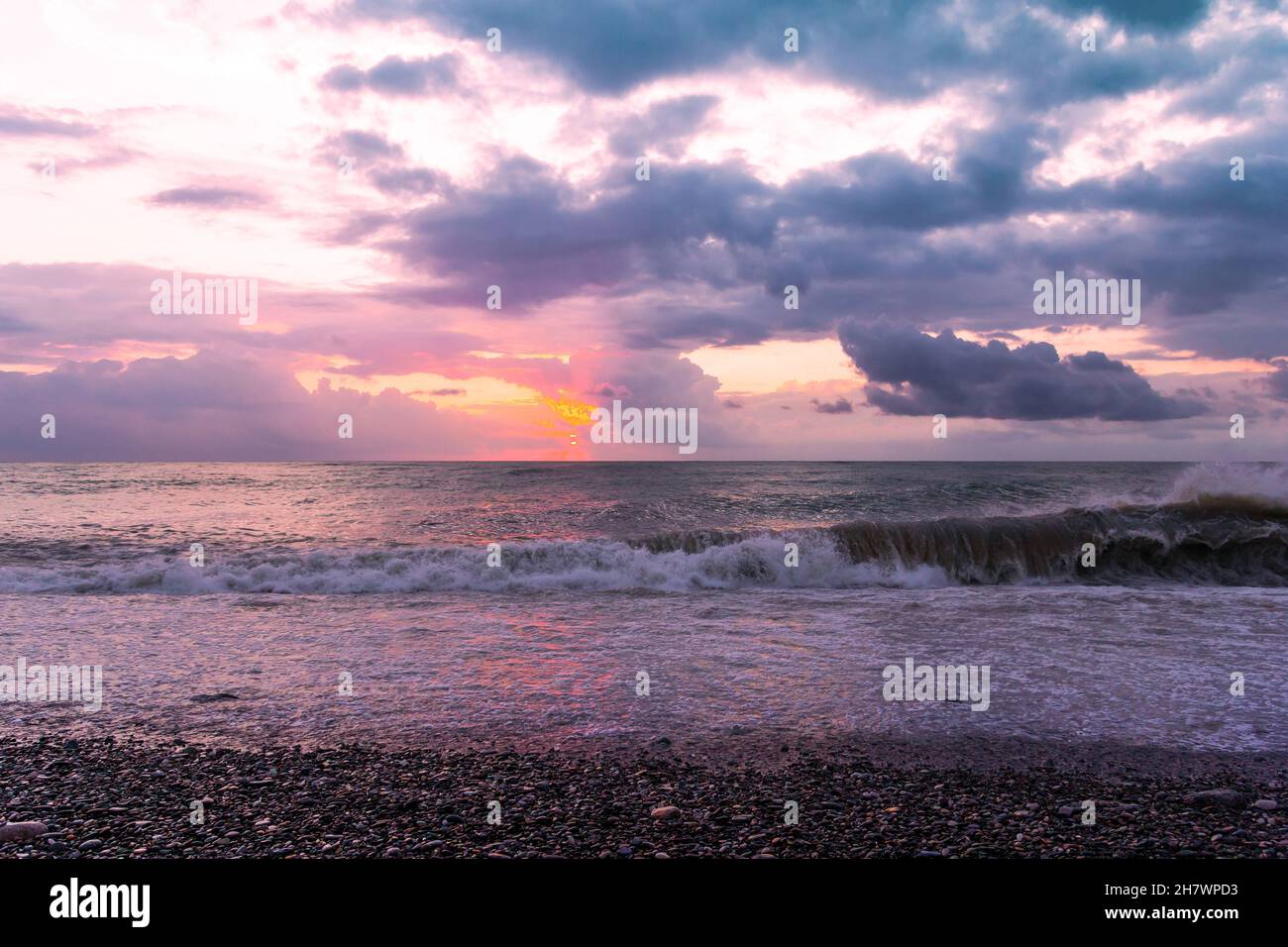 Fading waves and clearing skies after a storm Stock Photo - Alamy