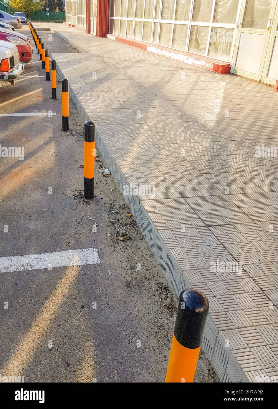 A row of restrictive striped orange and black pillars enclosing the ...