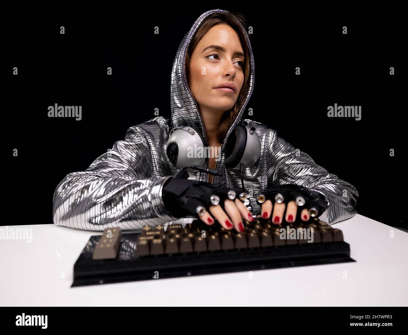 Woman with silver costume typing on keyboard Stock Photo - Alamy