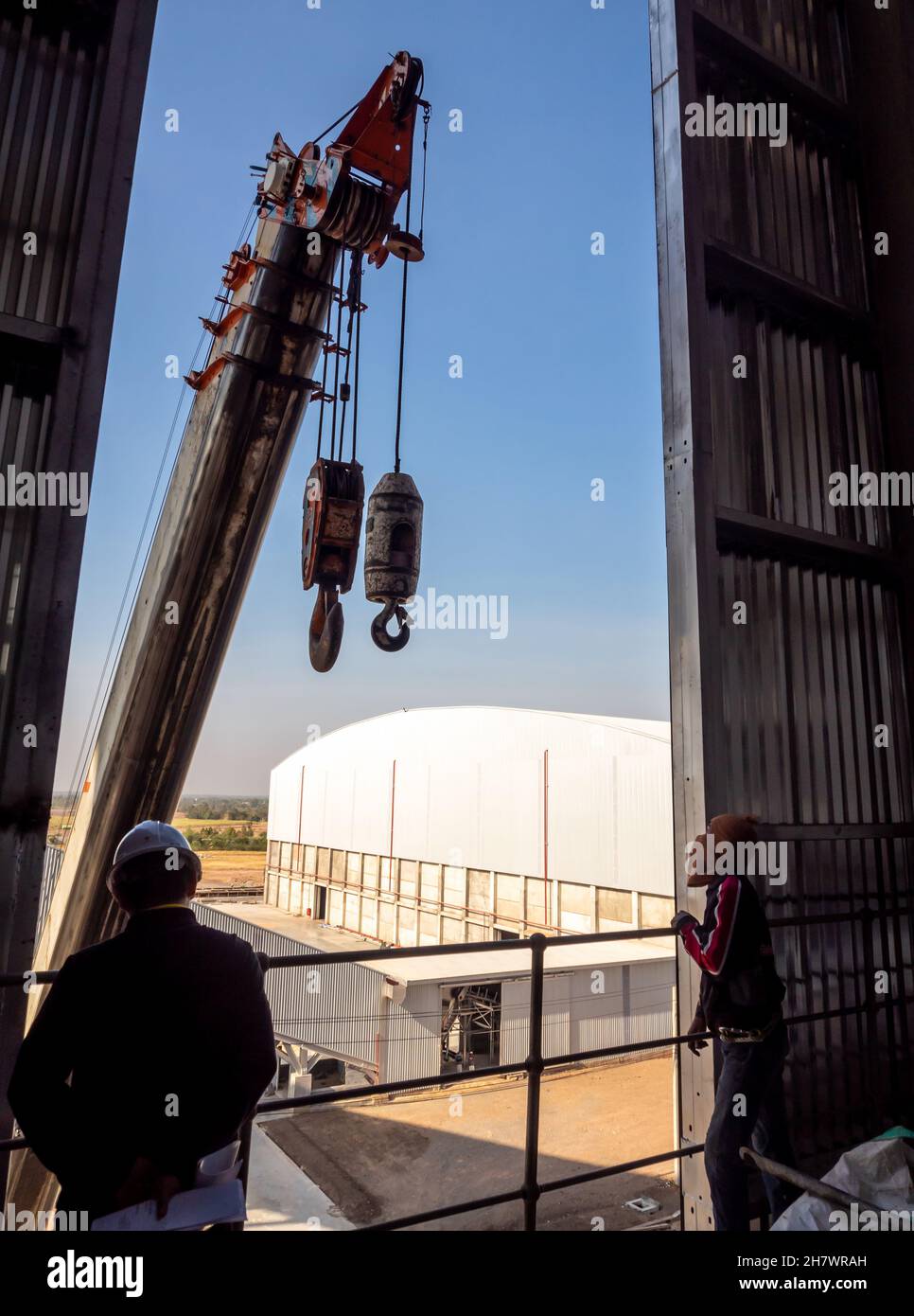 The hoist of the crane at the window of industrial plant Stock Photo ...