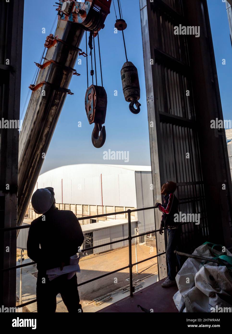 The hoist of the crane at the window of industrial plant Stock Photo ...